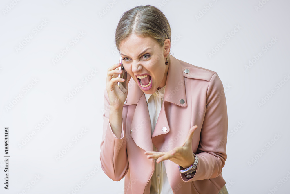 Angry furious business woman yelling at her phone, pointing fingers ...