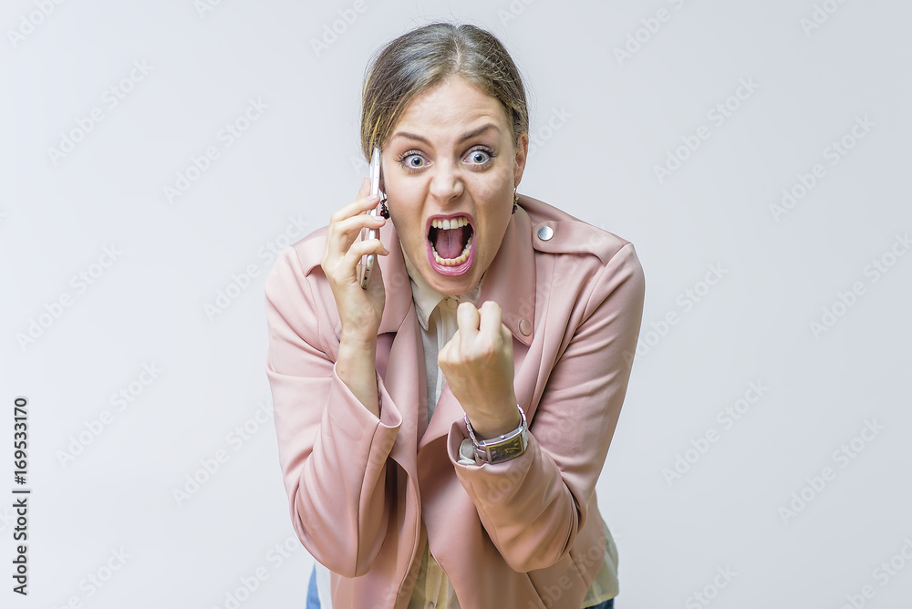 Angry furious business woman yelling at her phone, pointing fingers ...