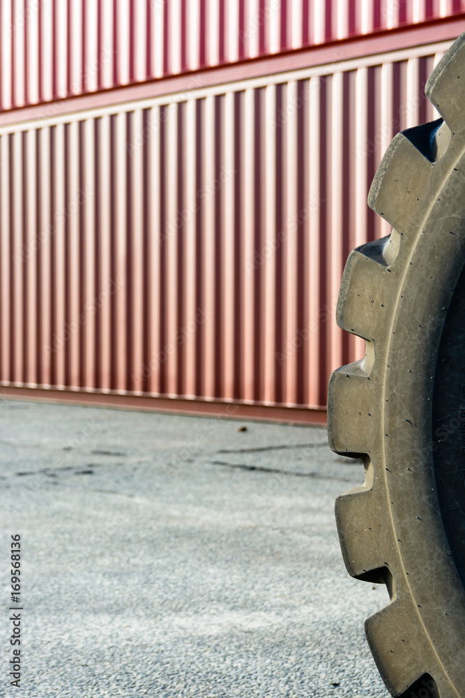 Close-up view of the tyre wheel of a reach stacker with stacked cargo ...