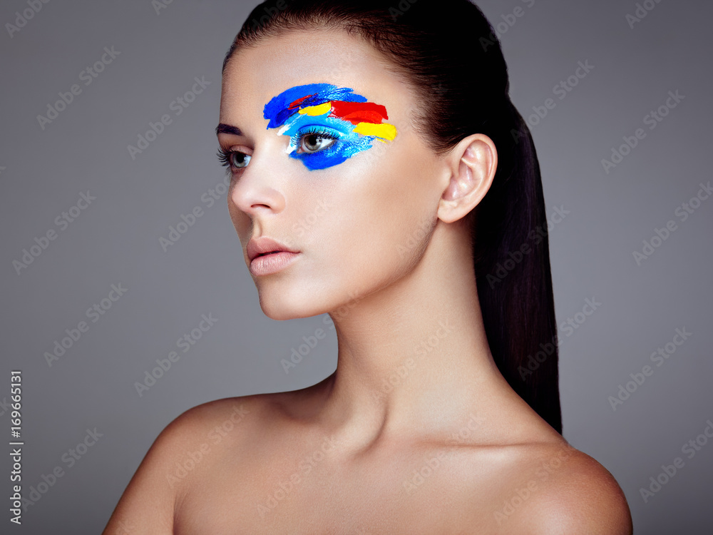 Fashion model woman with colored face painted. Beauty fashion art ...