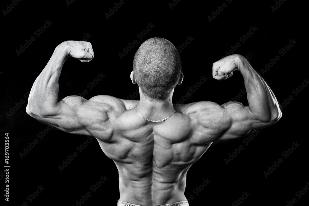 Back muscles. The athlete flexes his muscles. Bodybuilder presenting ...