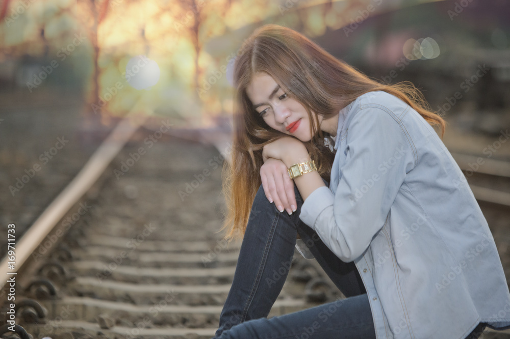 Asian girl wearing a stylish poses poses in the train station, the ...
