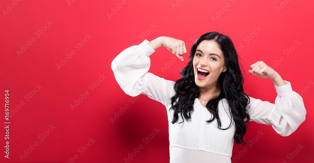 Powerful young woman a solid color background Stock Photo | Adobe Stock