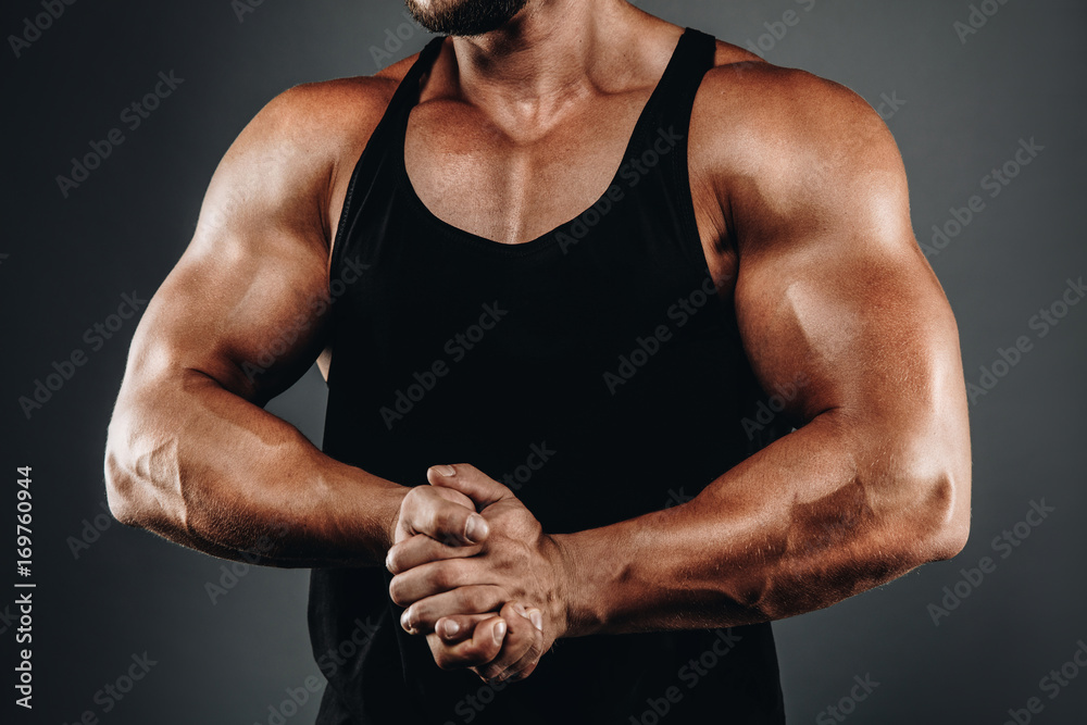 Strong athletic bodybuilder posing with perfect abs, shoulders, biceps ...