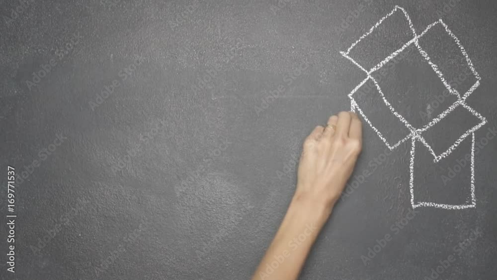 Woman's hand drawing box and writing "THINK OUTSIDE THE BOX" with white ...
