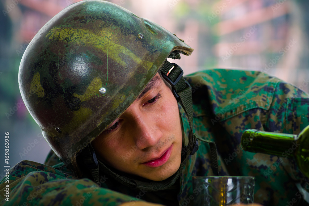 Handsome young soldier wearing uniform suffering from stress post-war ...