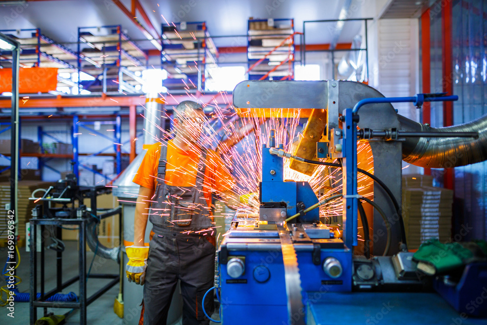 A male mechanic working on welding machine in the Industrial production ...