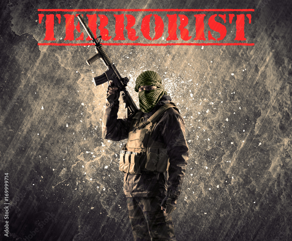 Portrait of man holding rifle with terrorist sign against grungy ...