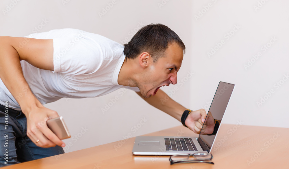 Angry man yelling at his computer Stock Photo | Adobe Stock