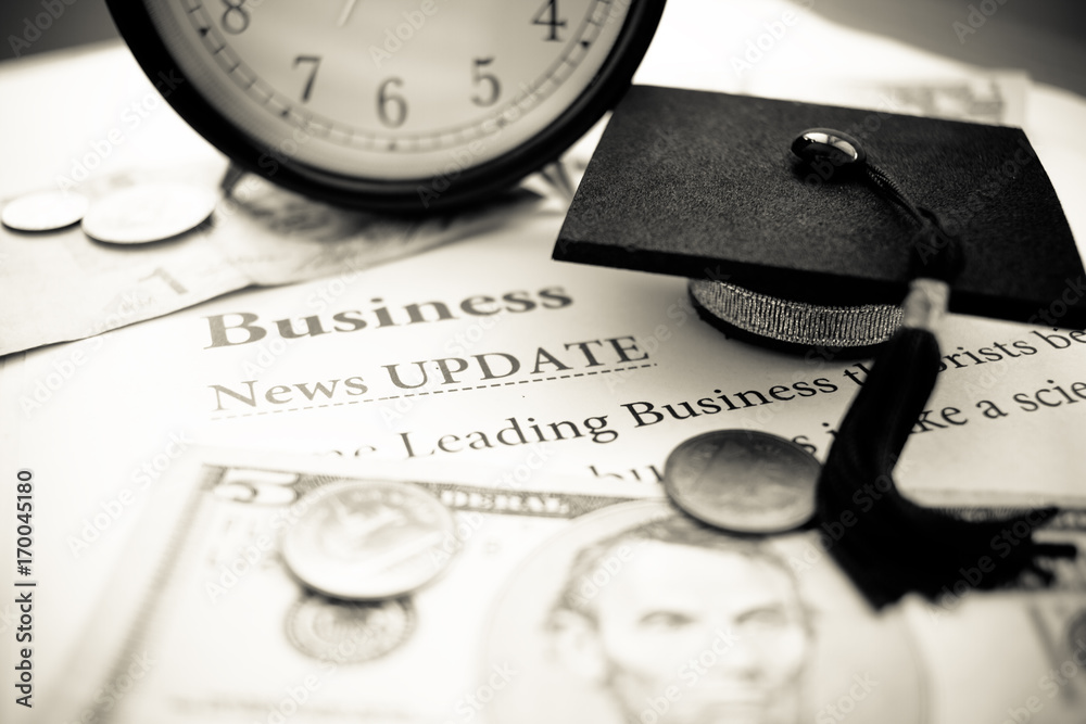 Concept of graduation black cap on roll up Dollars bill, with diploma ...