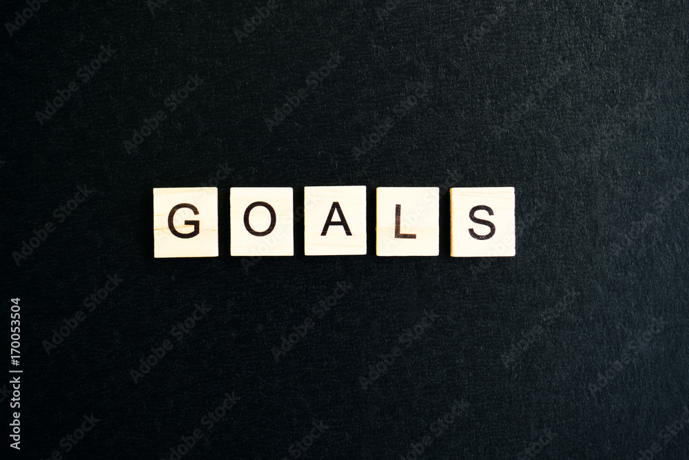 Goals words on wood blocks with black background with filter and analog ...