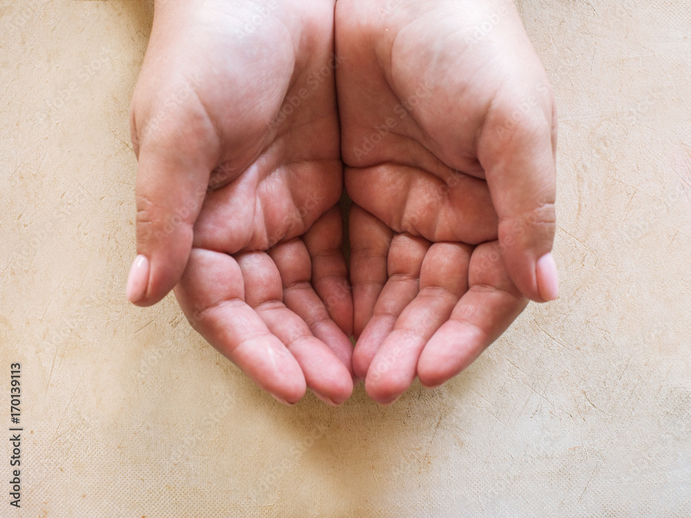 Cupped female hands on beige background. Charity and faith concept ...