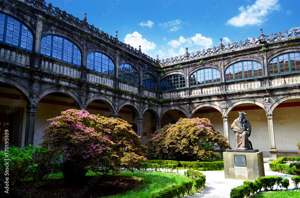Medieval palace with arch, garden, flower and priest statue Stock Photo ...