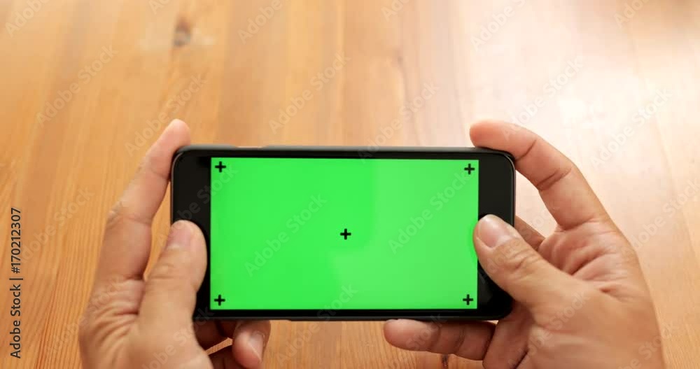 Playing game on cellphone with chroma key screen Stock Video | Adobe Stock