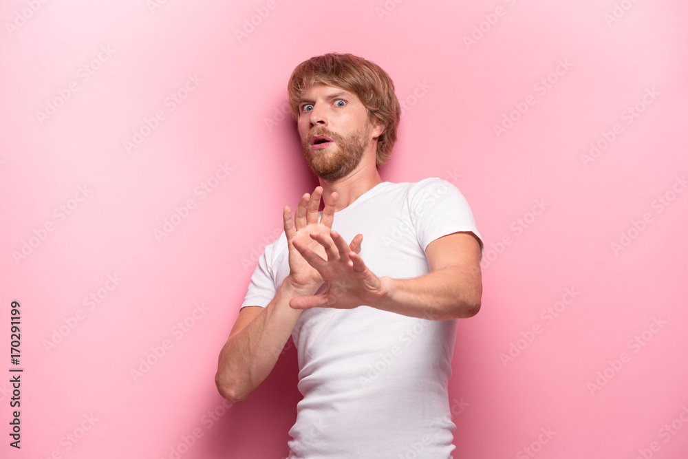Crazy desperate good-looking man being shocked looking at camera with ...