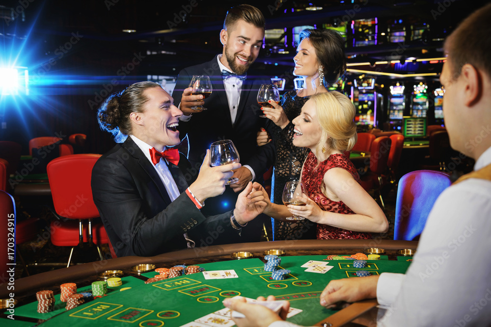 Happy people celebrating their win after successful game in the casino ...