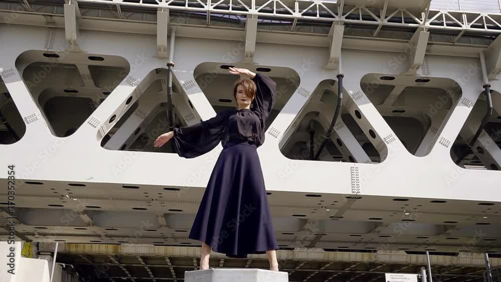stylish model girl in a dark blue long skirt is spreading her legs for ...