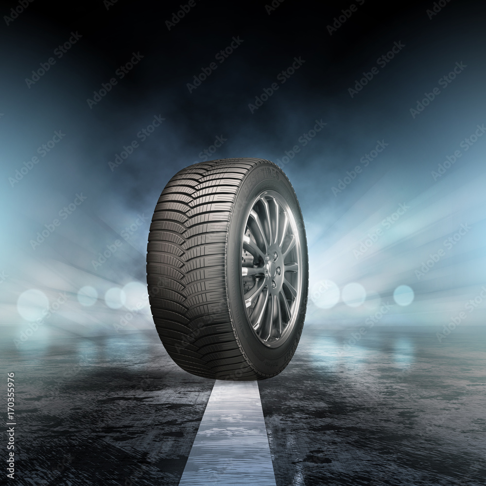Car tire standing on the night road in the light of headlights. Stock ...