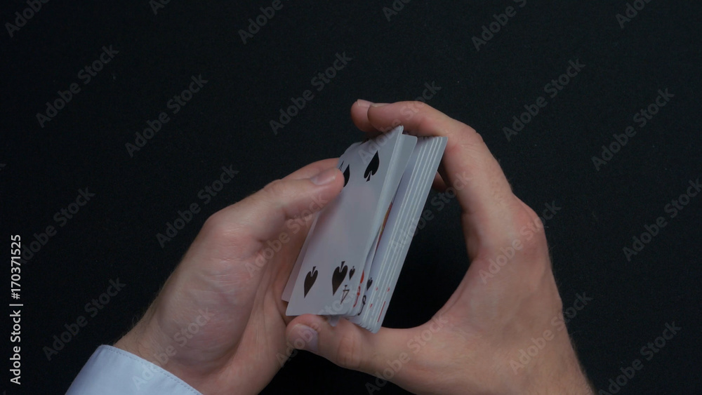 Poker game - shuffling cards. Man's hands shuffing cards. Close up. Man ...