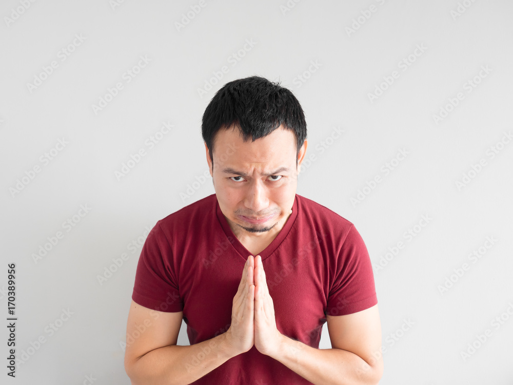 Sad man begging for forgiveness. Stock Photo | Adobe Stock