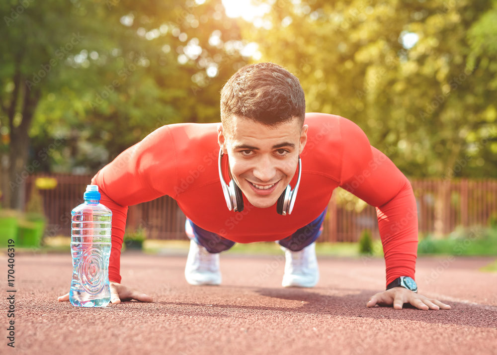 Sport fitness man push-ups. Male athlete exercising push up outside in ...