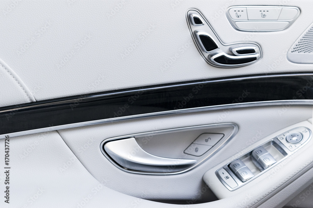 Door handle with Power seat control buttons of a luxury passenger car ...