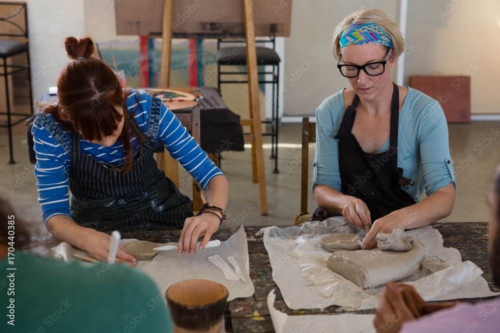 Female craftsperson practicing in art studio Stock Photo | Adobe Stock