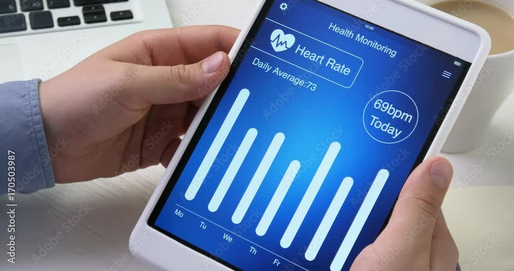 Checking heart rate monitoring on health app on the digital tablet ...