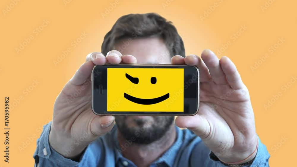 Winking Man Smiley Face On Smartphone Screen. Man shows his feelings ...