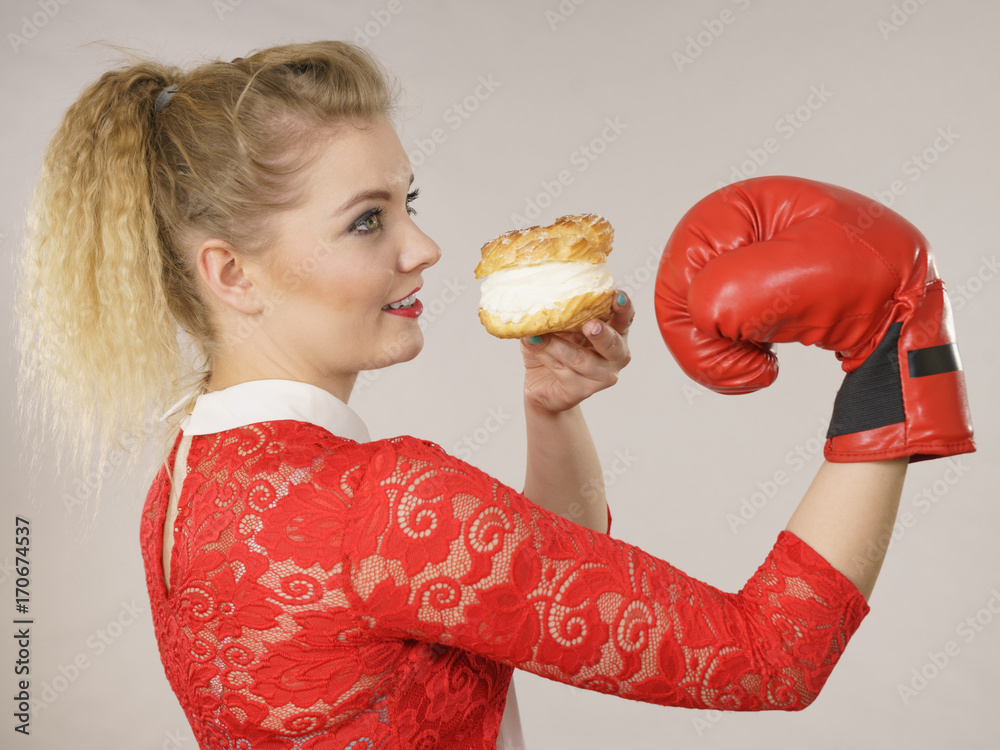 Woman fighting off bad food, boxing cream puff cake Stock Photo | Adobe ...