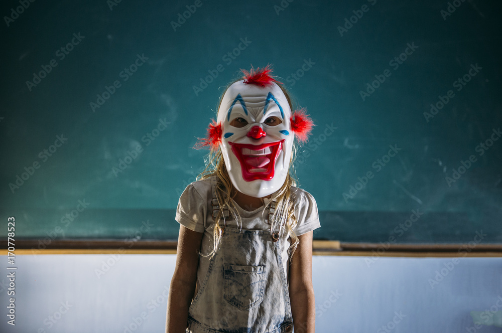 Child in scary clown mask Stock Photo | Adobe Stock