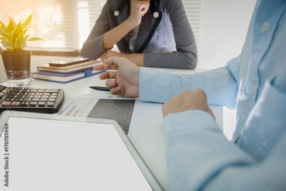Investor executive discussing plan financial graph data on office table ...