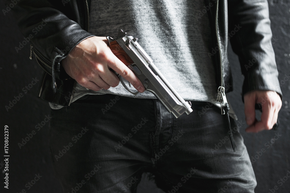 Hand holding pistol ready to shoot Stock Photo | Adobe Stock