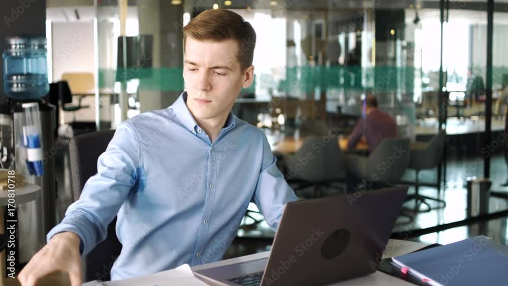 serious and concentrated young male manager full of ambitions work on ...