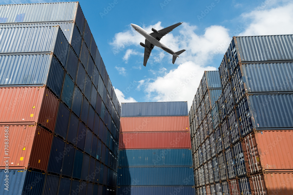 Stack of cargo containers with cargo airplane at import and export area ...