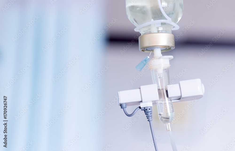 Close up saline solution drip for patient and infusion pump in hospital ...