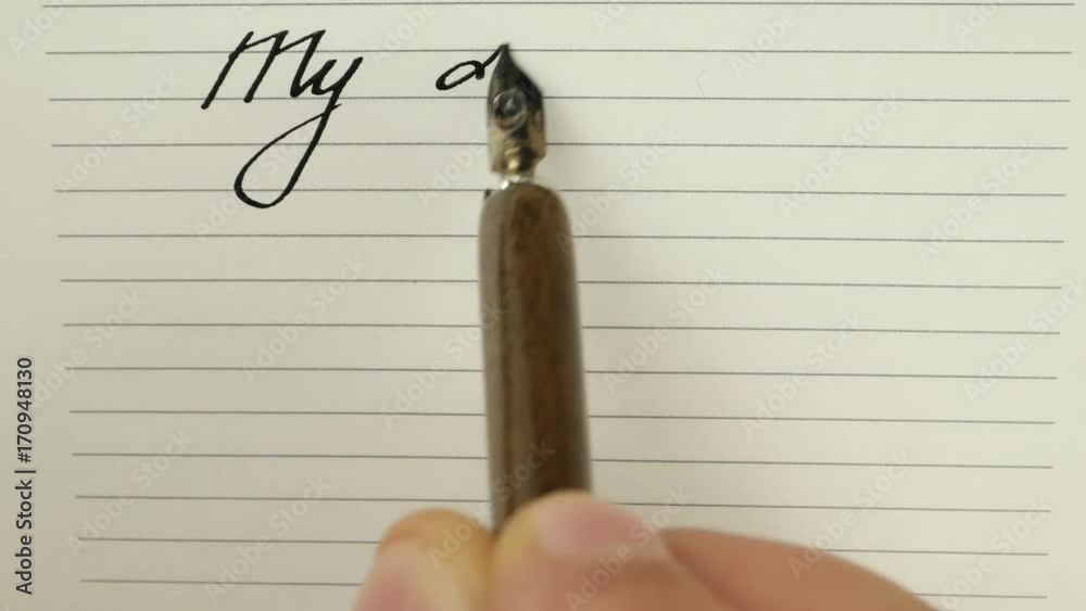 Writing of a greeting in the letter with ink and a fountain pen on the ...