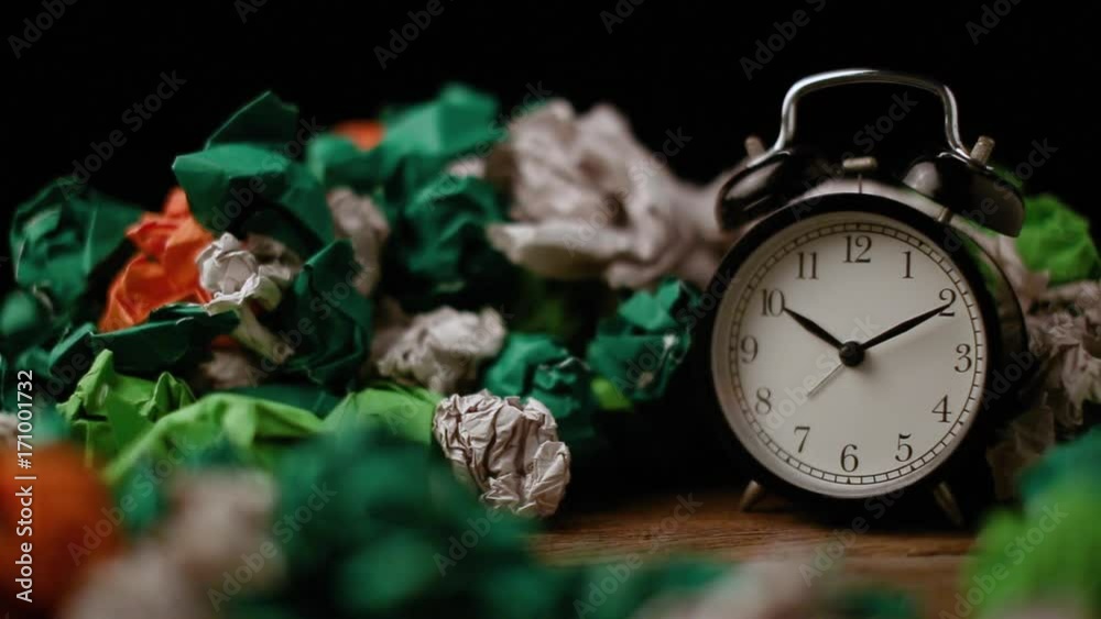 Alarm clock in a wastepaper concept for a time waste of time with cork ...