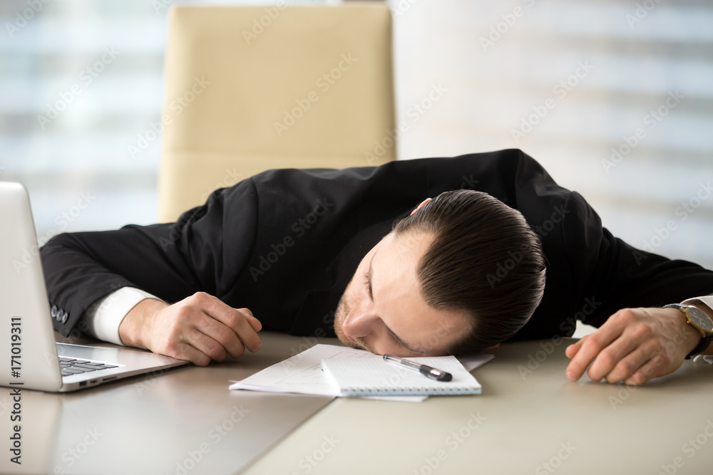 Exhausted businessman passed out at workplace desk in office. Tired ...