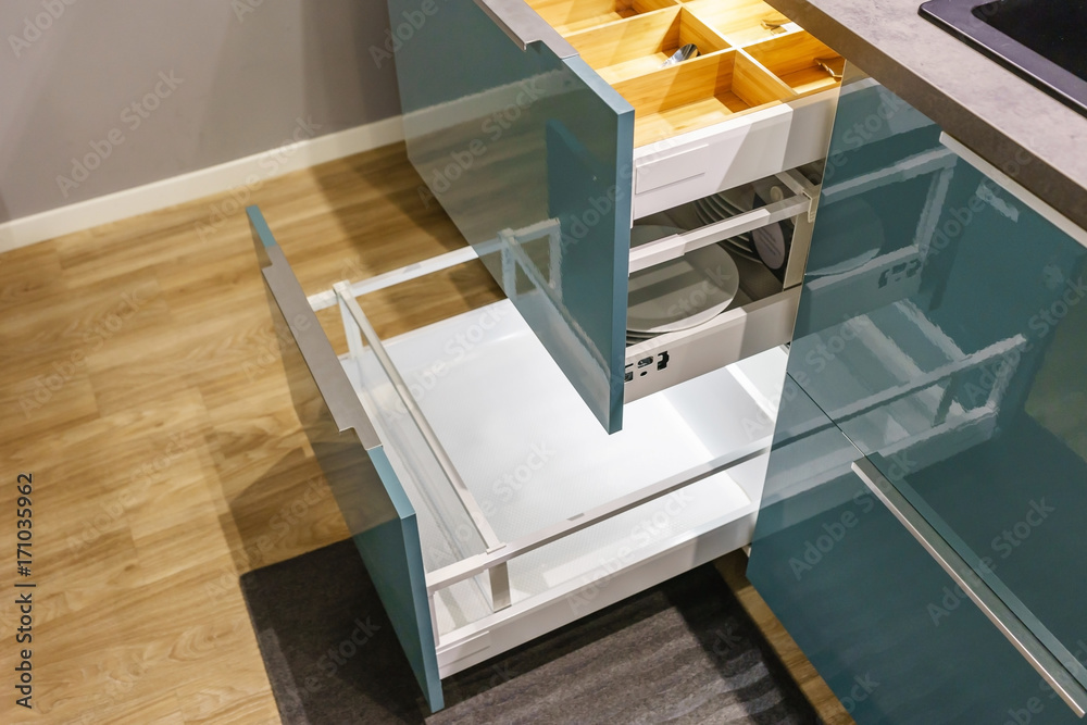 Opened kitchen drawer with plates inside, a smart solution for kitchen ...