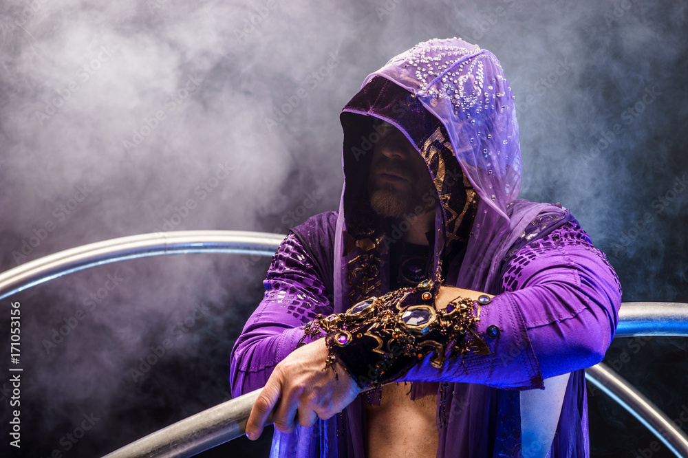 Assassin. Fairy-tale character in a bright purple suit with a hood and ...