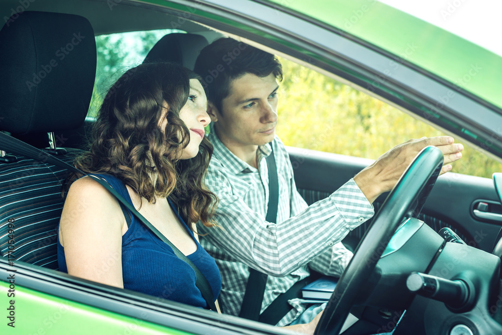 Driving instructor teaching driving in the car the woman beginner ...