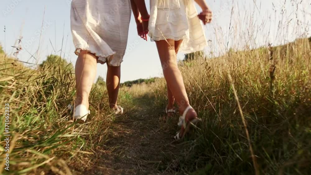 Close up view of happy children in a white dresses dancing, whirling ...