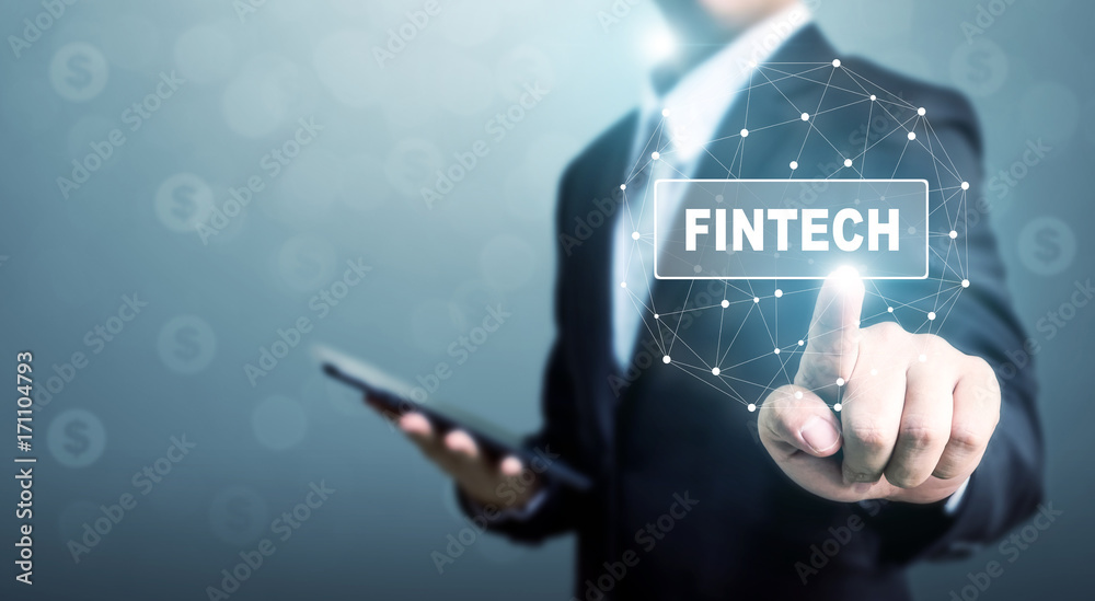 Businessman hand touching fintech (financial technology) with blurred ...