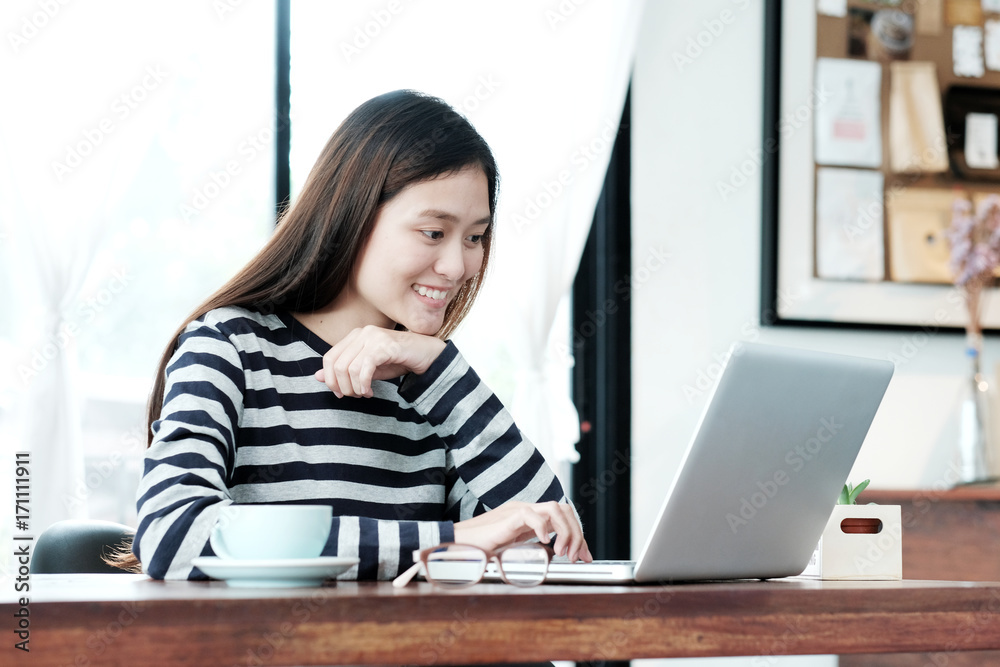 Young asian woman using laptop computer in casual lifestyles, people ...