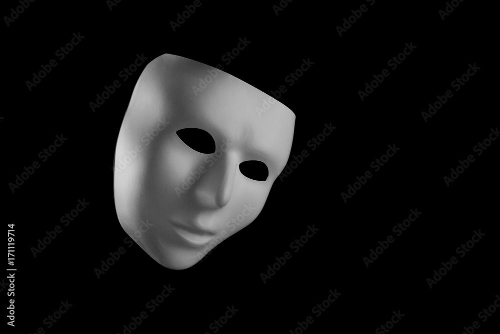 White mask looking down isolated on black background with copy space ...