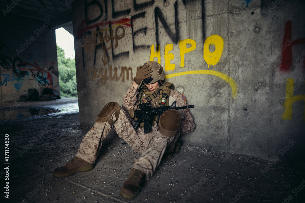 airsoft soldier with a rifle playing strikeball In an abandoned brick ...