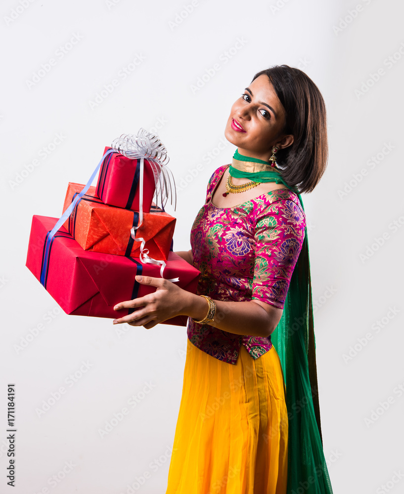 stock photo of beautiful indian girl holding stack of gift boxes ...