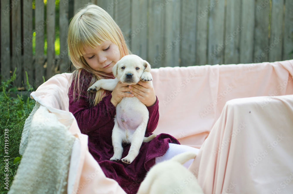 Little blond girl with the puppy on her hands. Cute friends - blonde ...