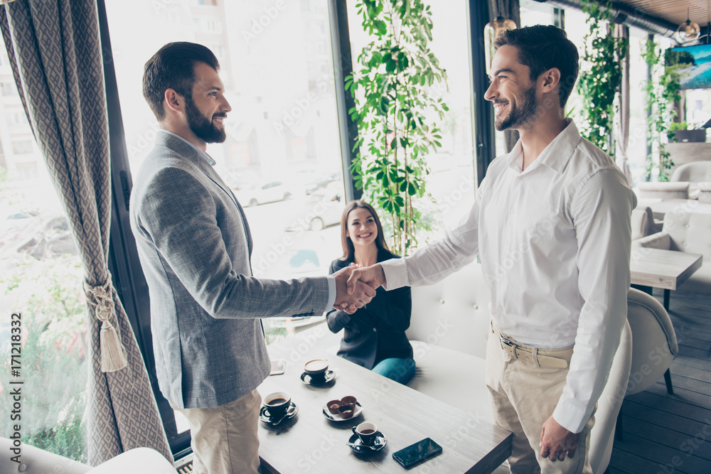 Side profile shot of two business partners in formal outfits making a ...